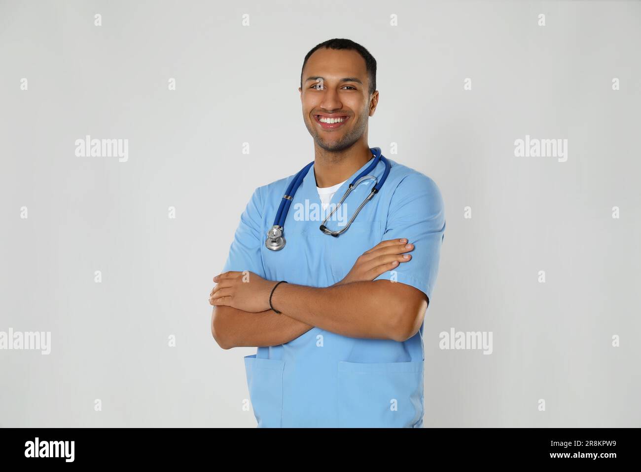 Doctor or medical assistant (male nurse) in uniform with stethoscope on ...