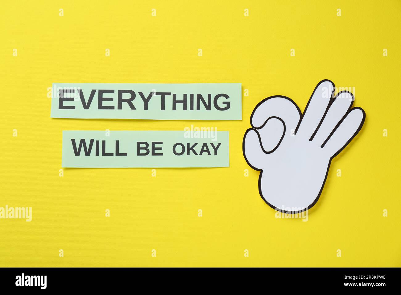 Cards with phrase Everything Will Be Okay and paper cutout of gesture ...