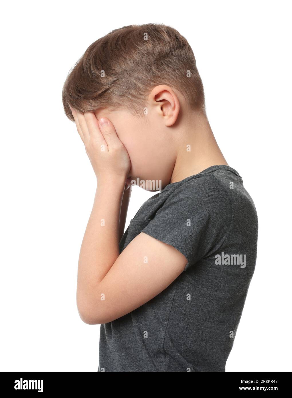 Boy covering face with hands on white background. Children's bullying ...