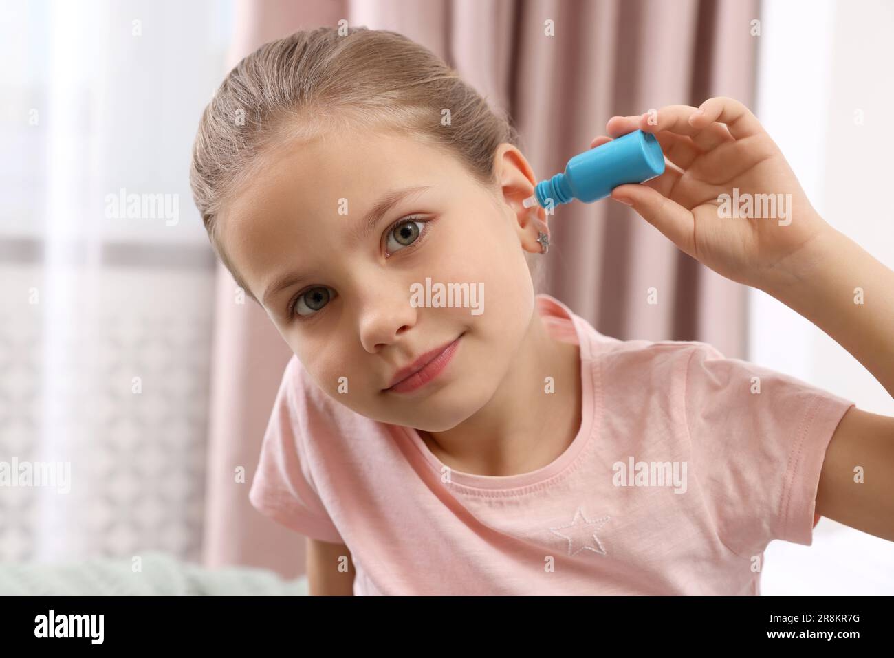 Little girl using ear drops at home Stock Photo - Alamy
