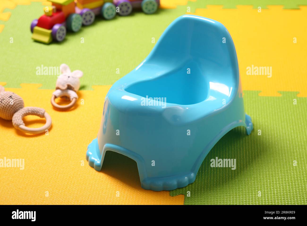 Light blue baby potty on colorful puzzle mat. Toilet training Stock ...