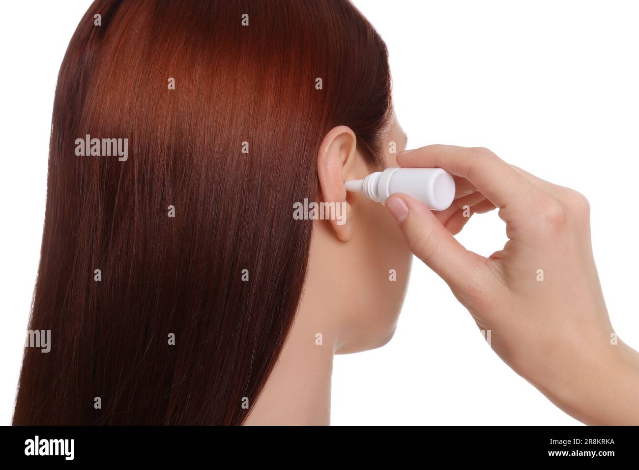 Woman using ear drops on white background Stock Photo - Alamy