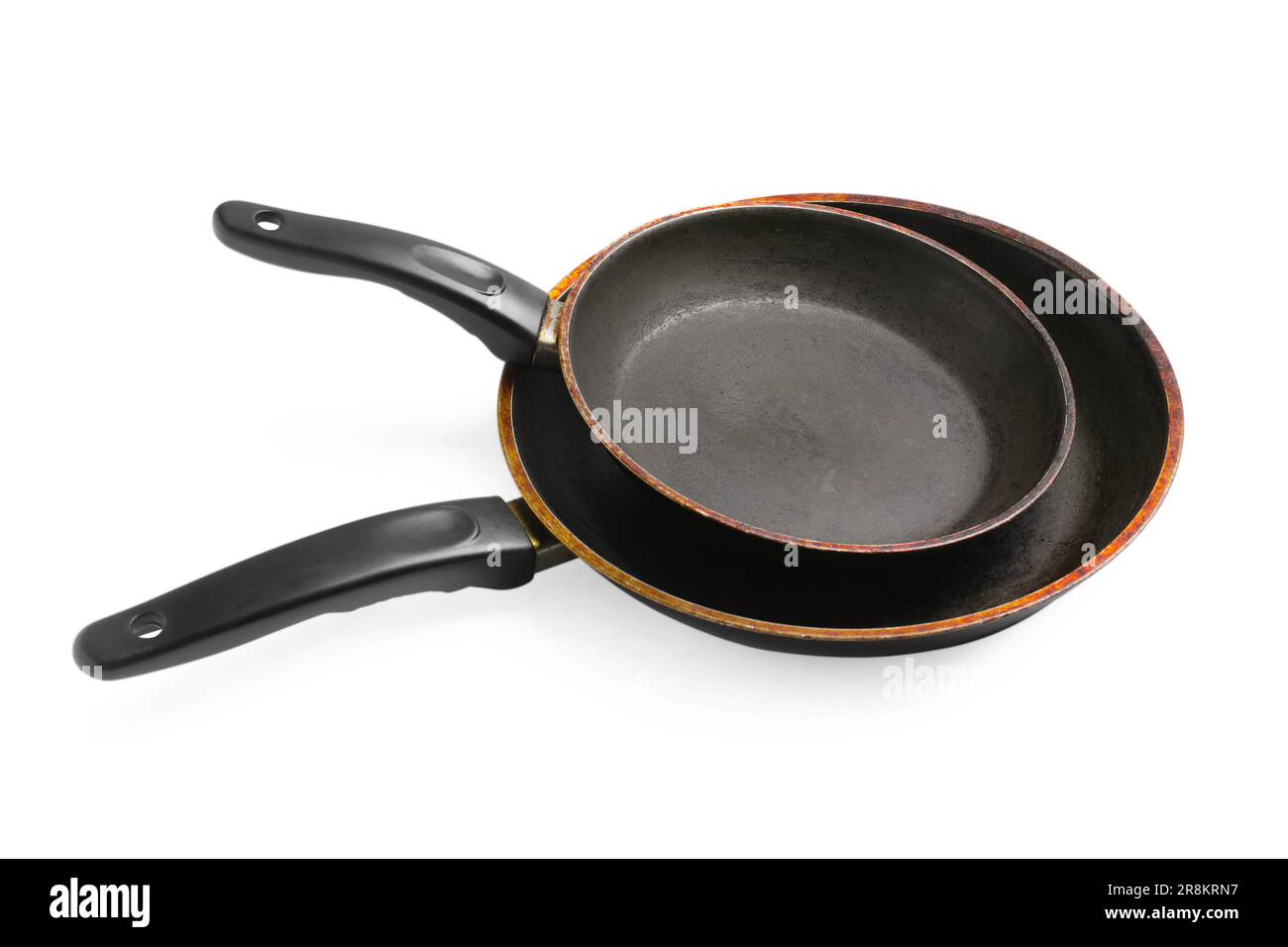 Dirty old frying pans on white background Stock Photo - Alamy