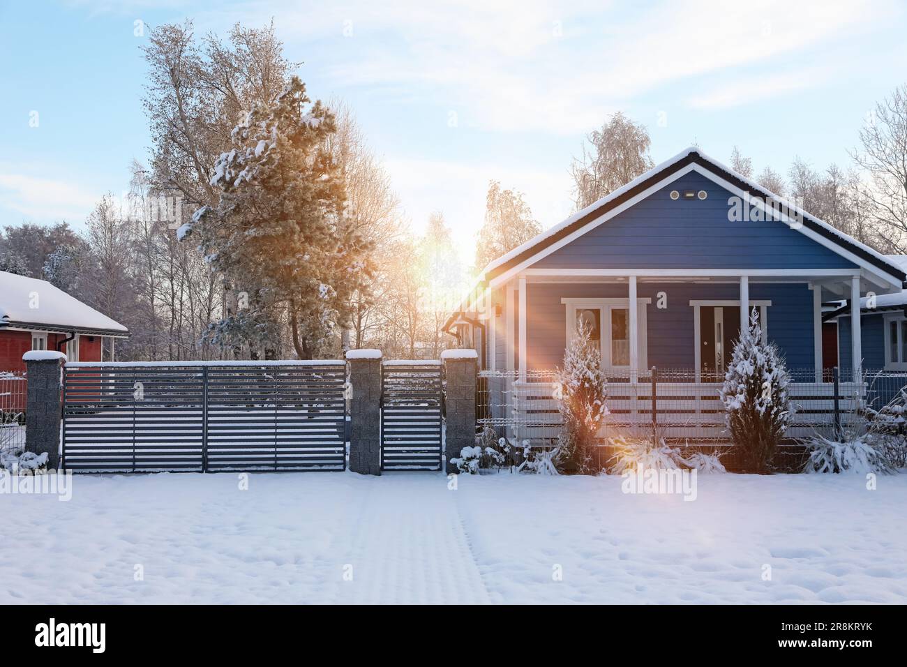 Winter landscape with beautiful houses, trees and bushes in morning ...