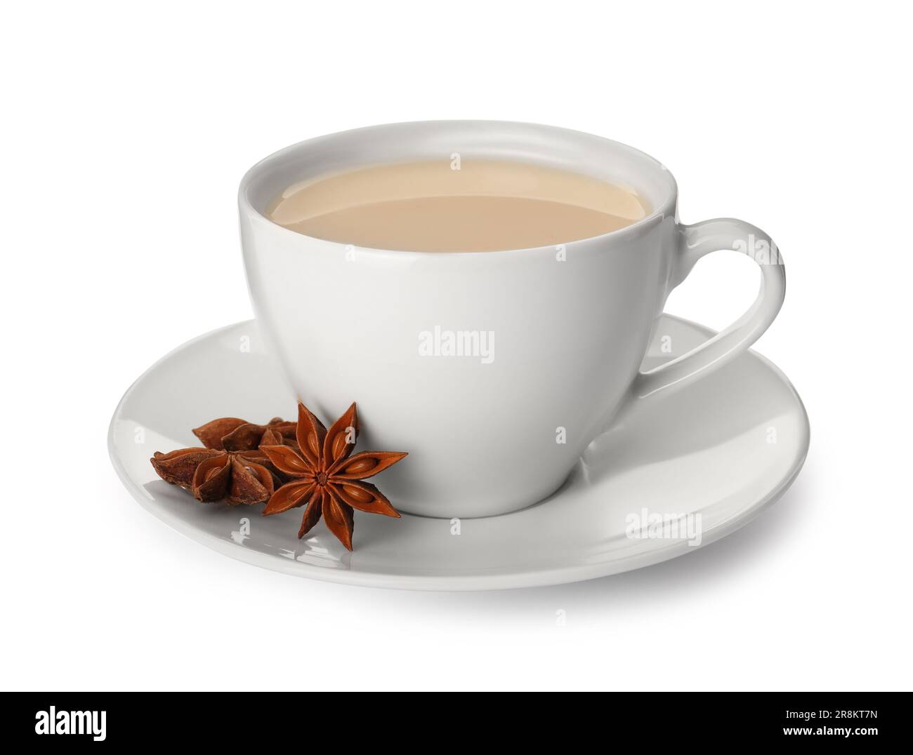 Cup of tea with milk and anise stars on white background Stock Photo ...