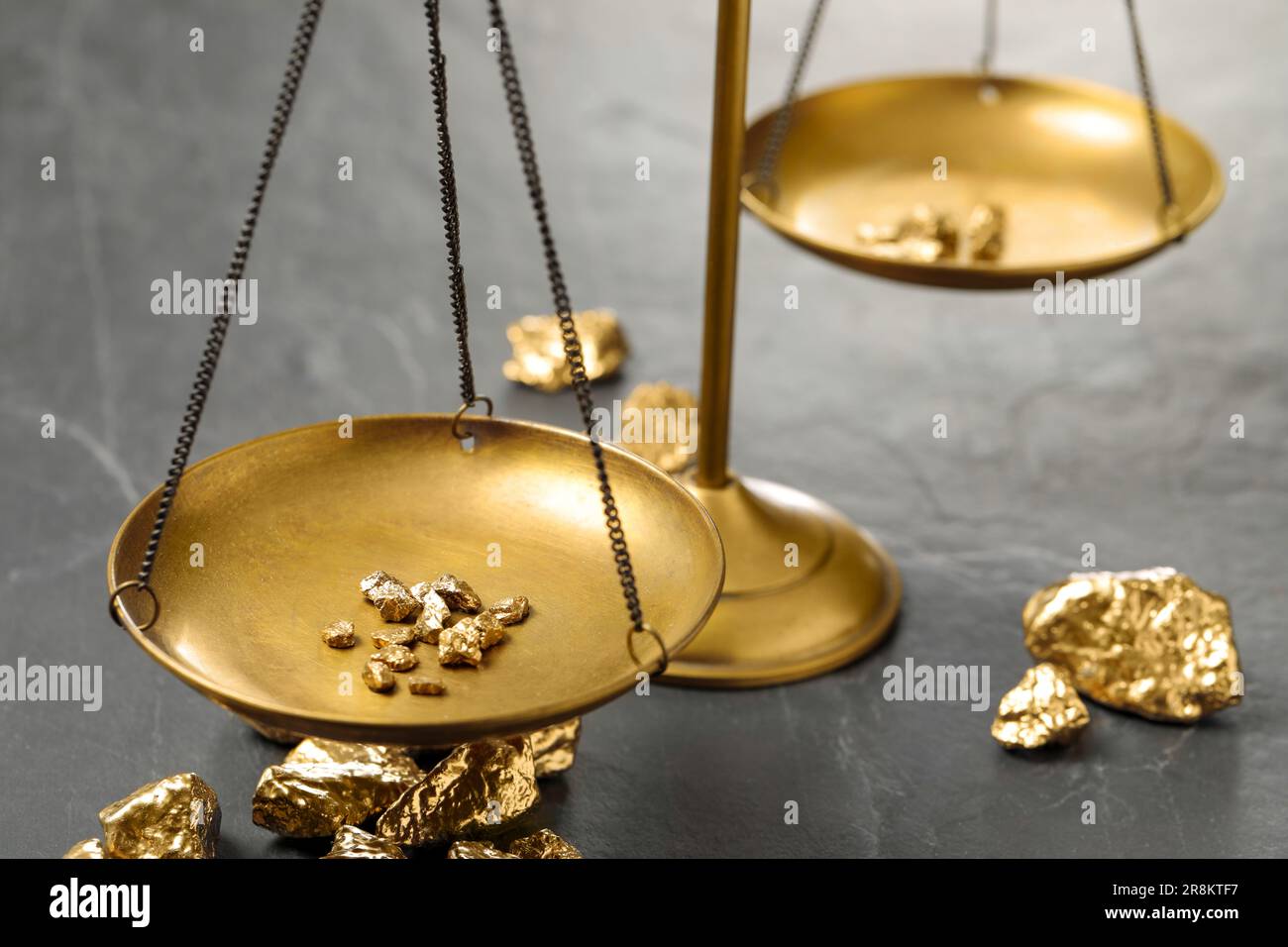 Vintage scales with gold nuggets on black marble table Stock Photo - Alamy
