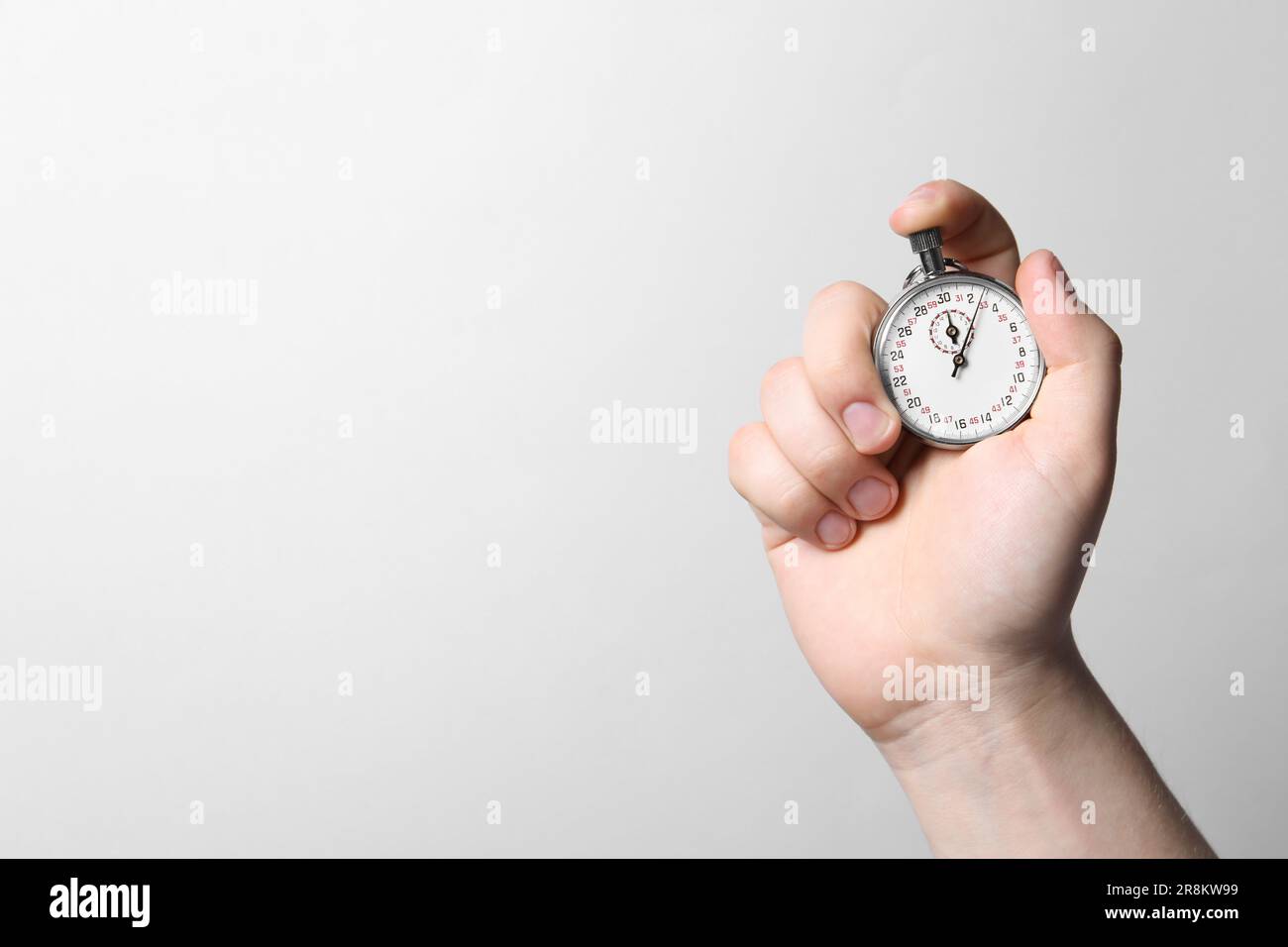 Man holding vintage timer on white background, closeup. Space for text ...