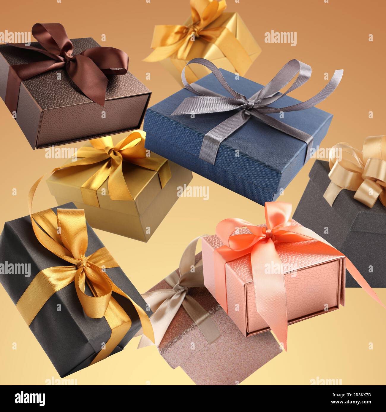 Many beautiful gift boxes falling on pale orange and yellow gradient ...
