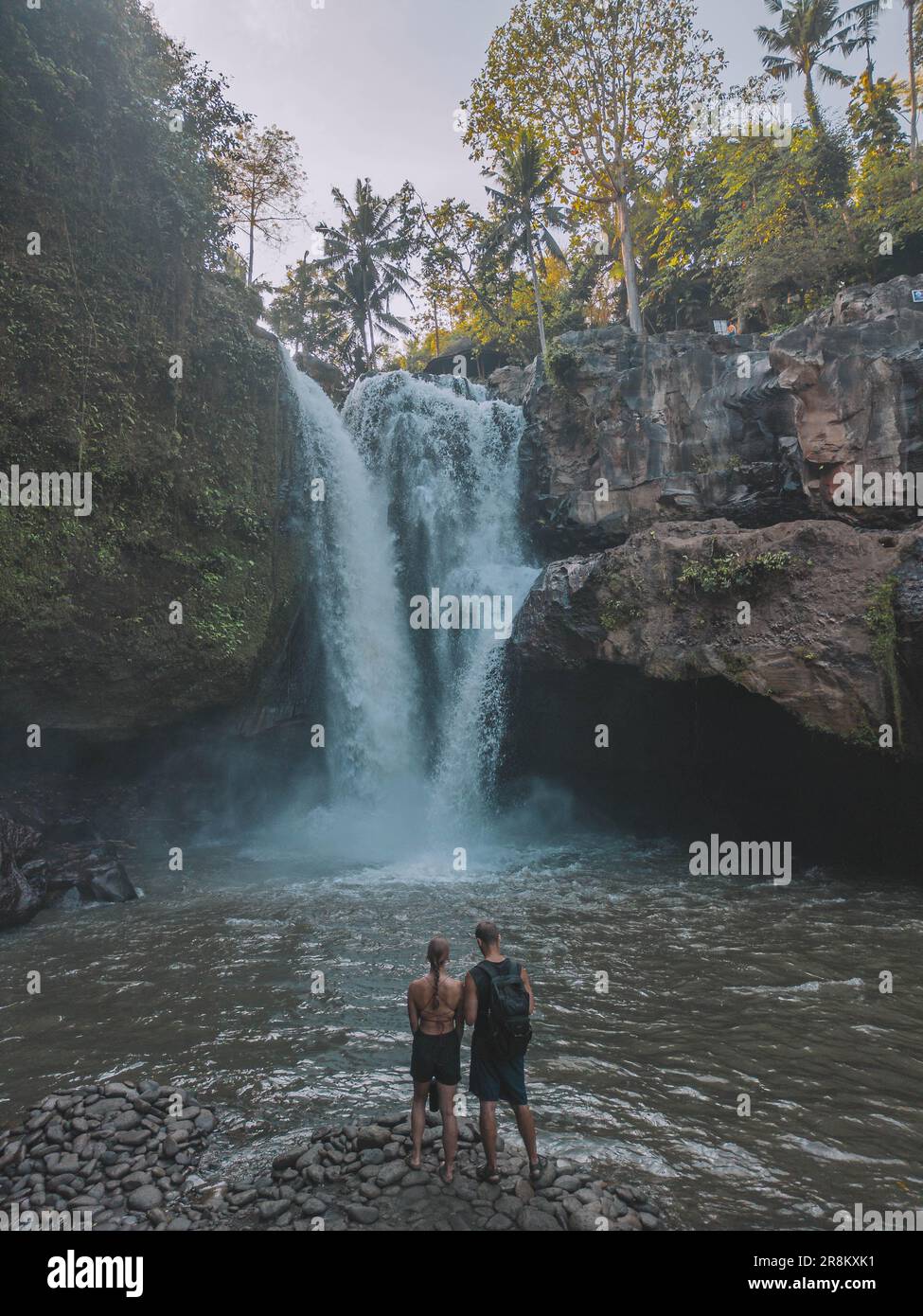 couple enjoying waterfall in Bali, Indonesia Stock Photo - Alamy