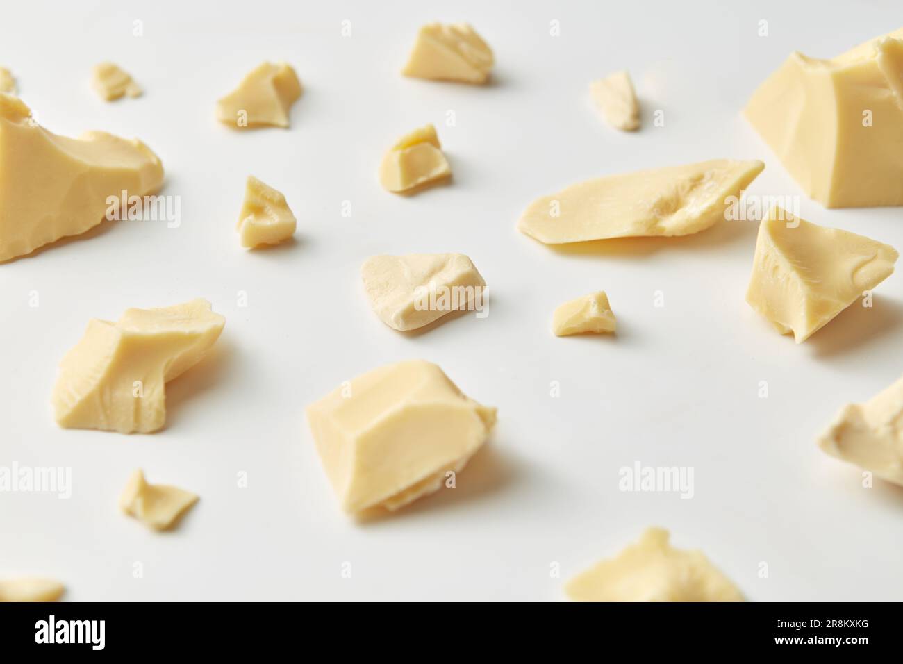 Homemade white chocolate chunks on plain background Stock Photo - Alamy