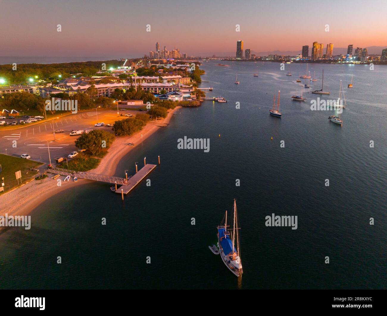 Aerial view of boast and yachts at anchor on a calm bay during twilight ...