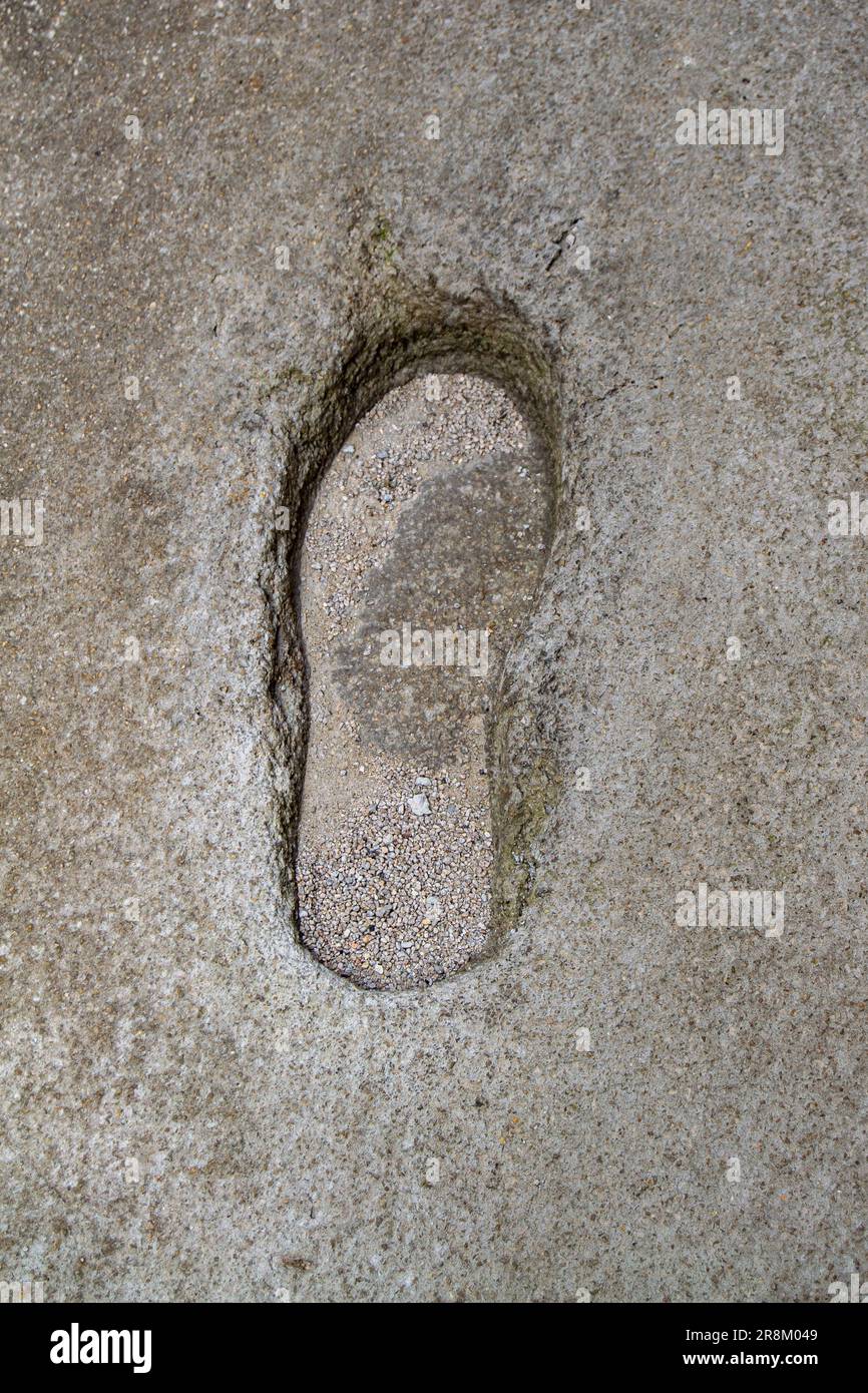 Deep left shoe print on the concrete floor of a street Stock Photo - Alamy