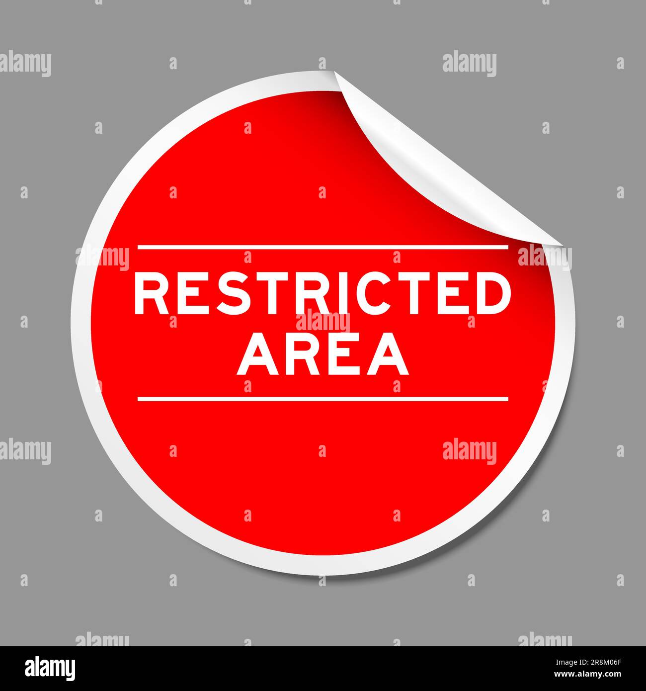 Red color peel sticker label with word restricted area on gray ...