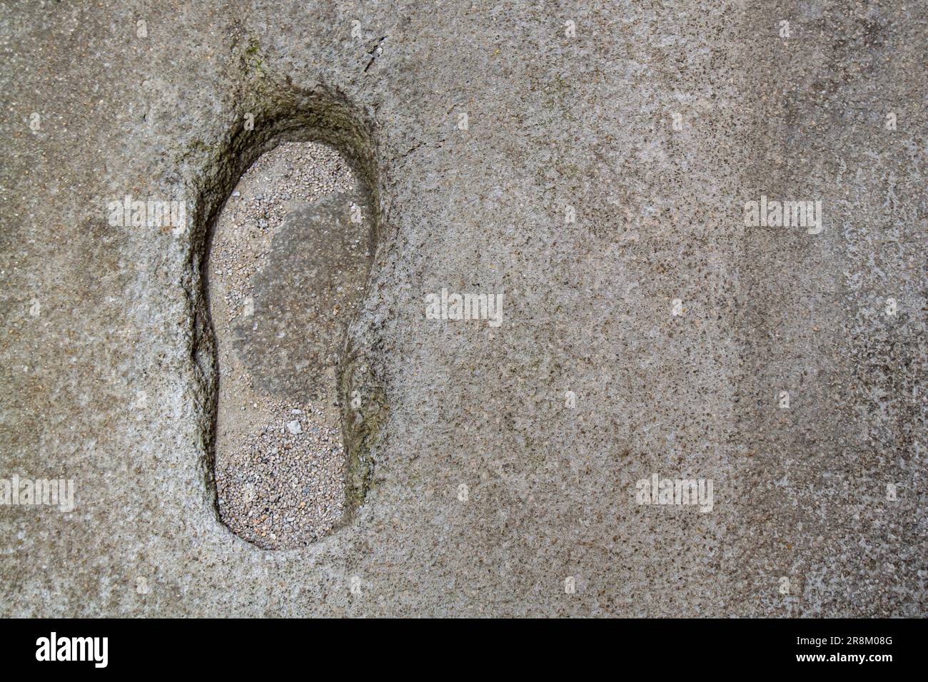 Deep left shoe print on the concrete floor of a street Stock Photo - Alamy