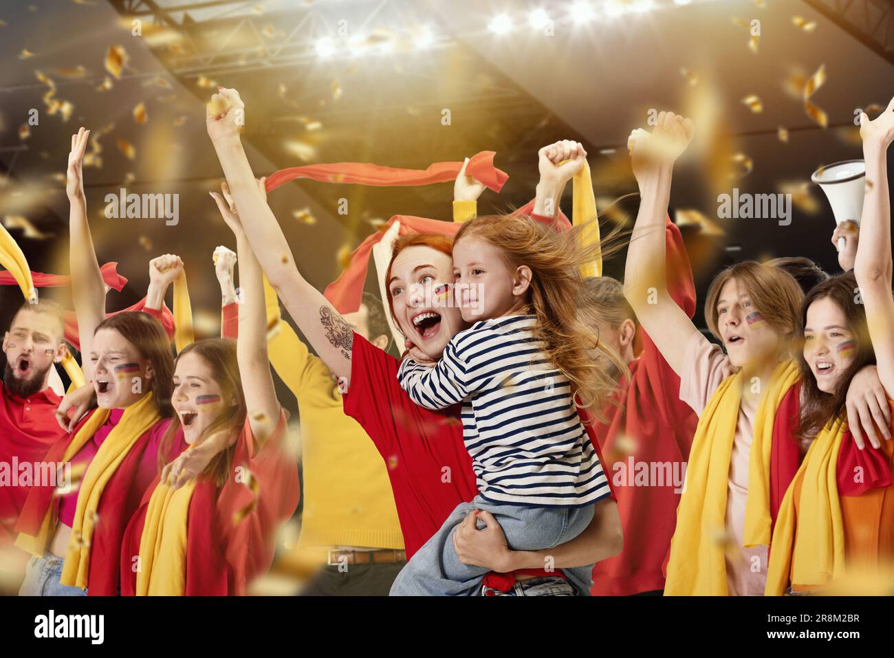 Happy young woman with little girl attending football match, fans ...