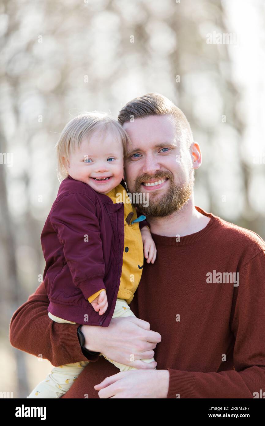 Portrait of father and smiling baby with down syndrome Stock Photo - Alamy