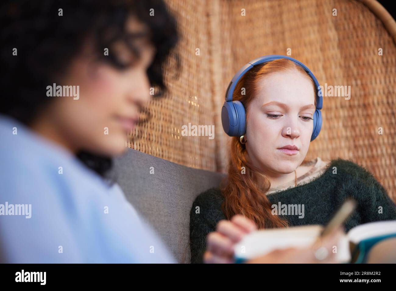 Women with headphones reading hi-res stock photography and images - Alamy