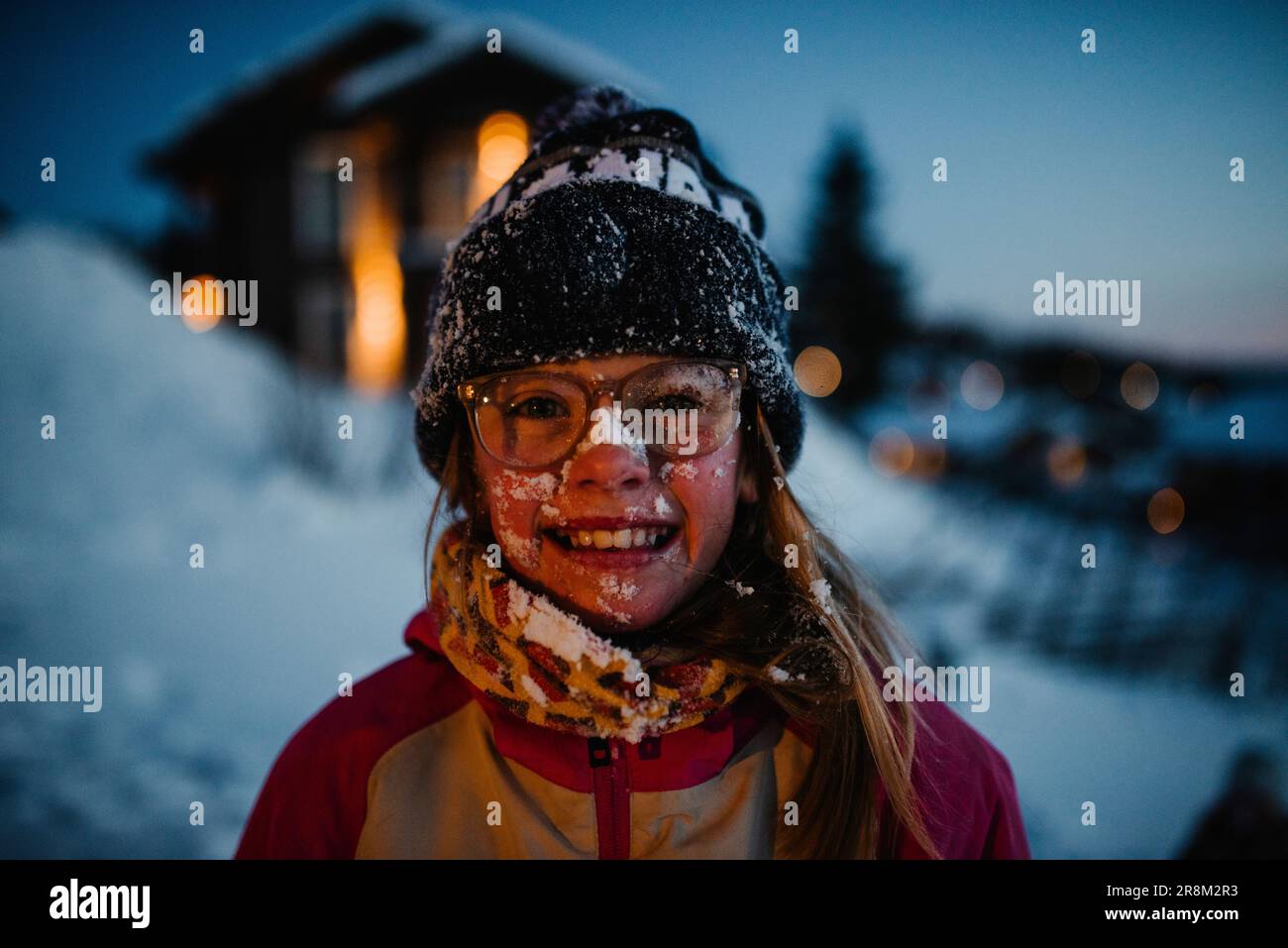 Happy girl covered in snow looking at camera Stock Photo - Alamy
