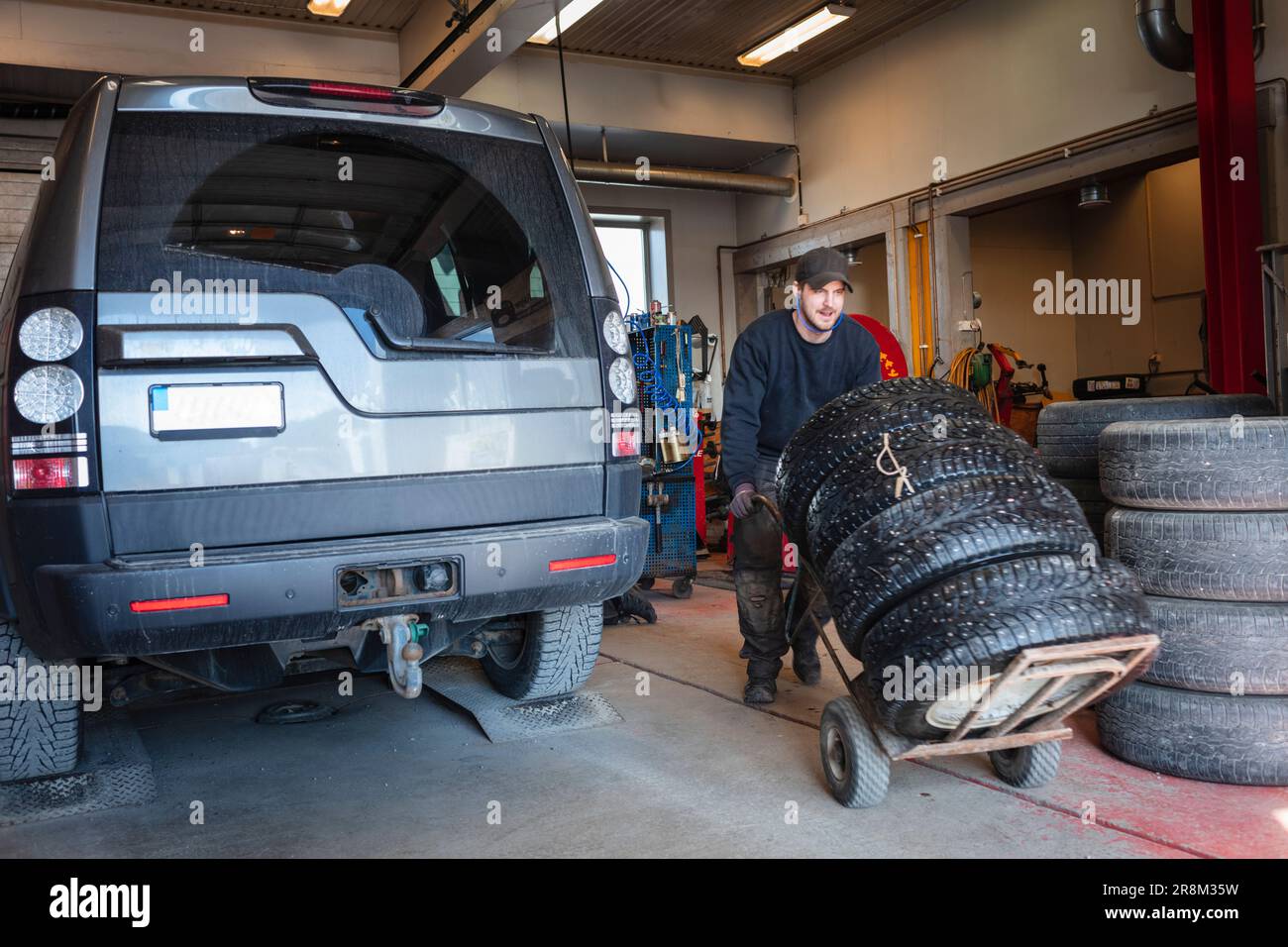 Repair mechanic working on car in garage hi-res stock photography and ...