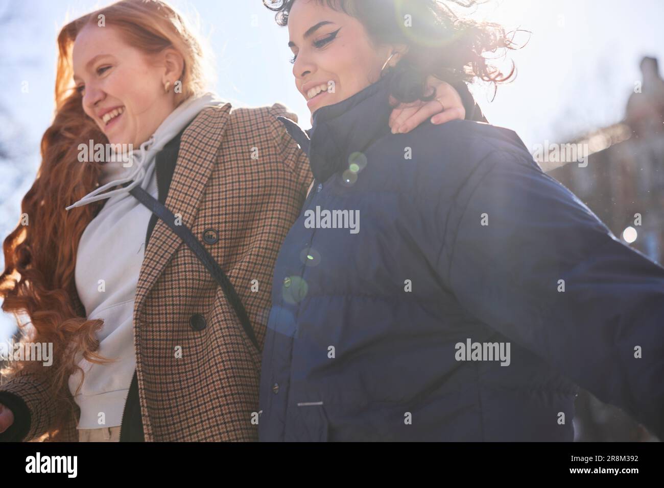 Females walking arm in arm hi-res stock photography and images - Alamy