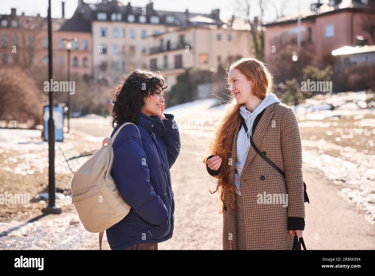 Female friends talking together in city surroundings Stock Photo - Alamy
