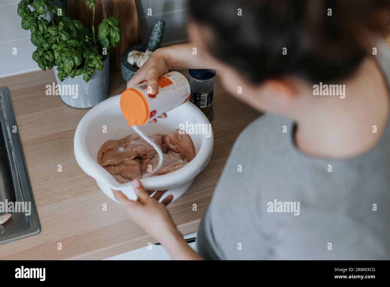 Person putting food in bowl hi-res stock photography and images - Alamy