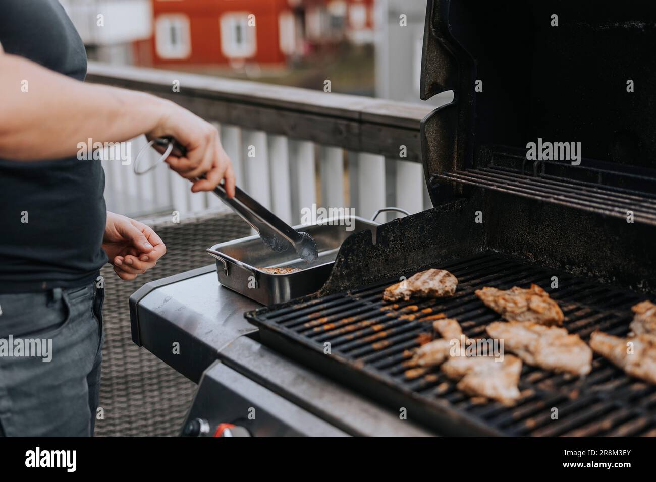 Hand holding cooking tongs hi-res stock photography and images - Alamy