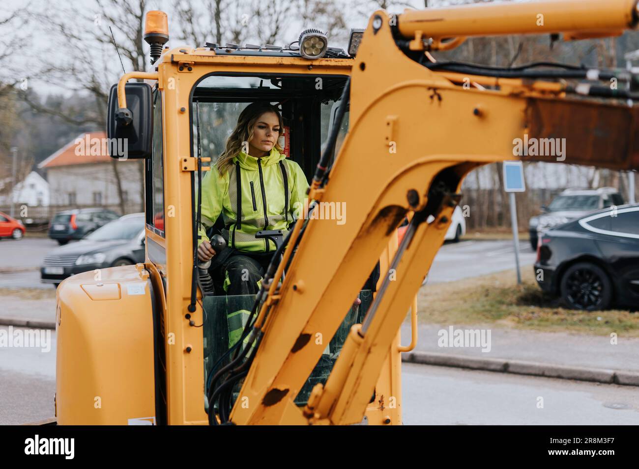 Female road worker operating excavator Stock Photo - Alamy