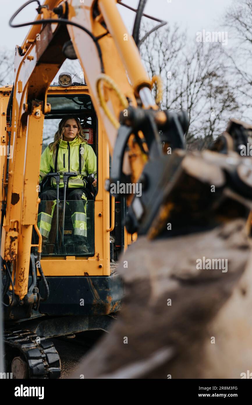 Female road worker operating excavator Stock Photo - Alamy