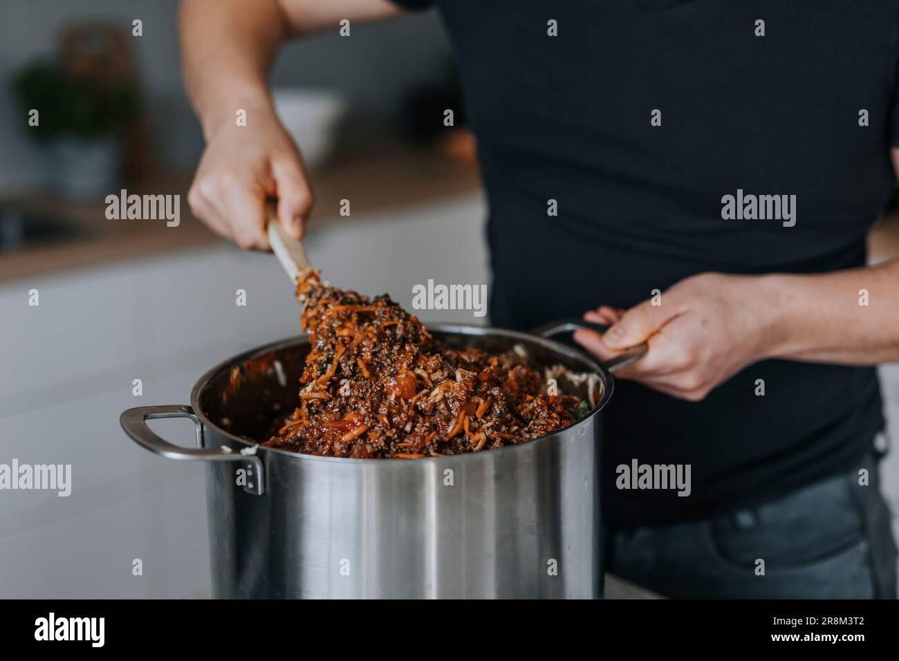 Man's hands mixing food in saucepan Stock Photo - Alamy
