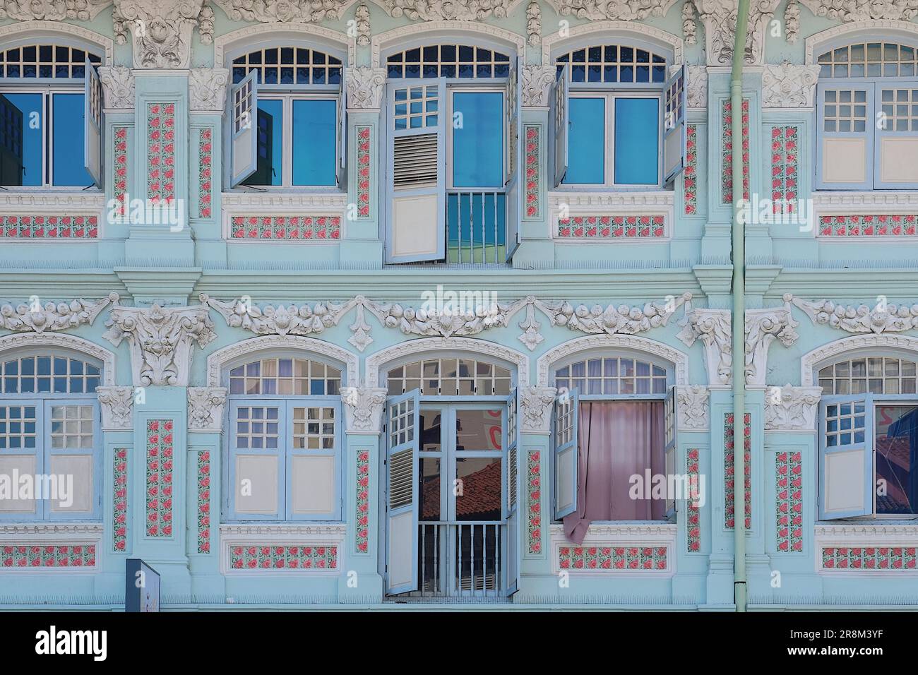 Facade of a row of light blue Straits Chinese Peranakan residential ...