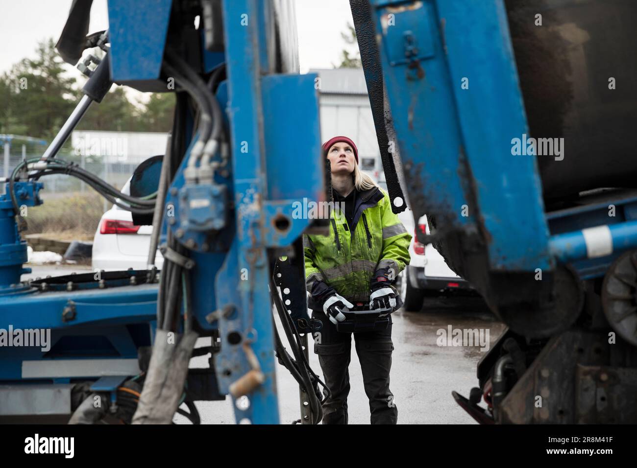Young female construction worker operating machinery Stock Photo - Alamy