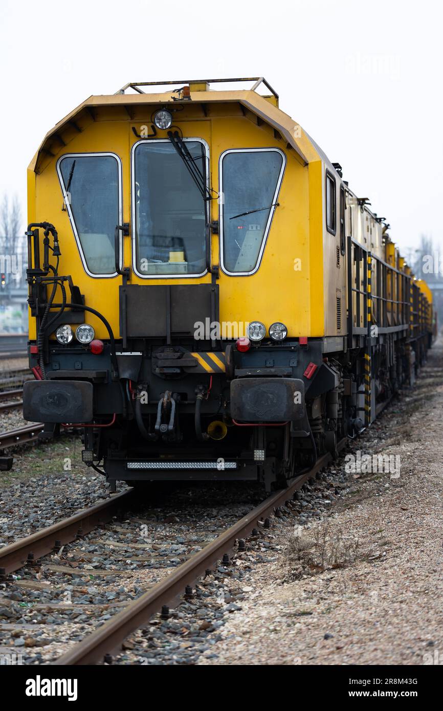 A yellow technical train for grinding rails standing on a railway ...