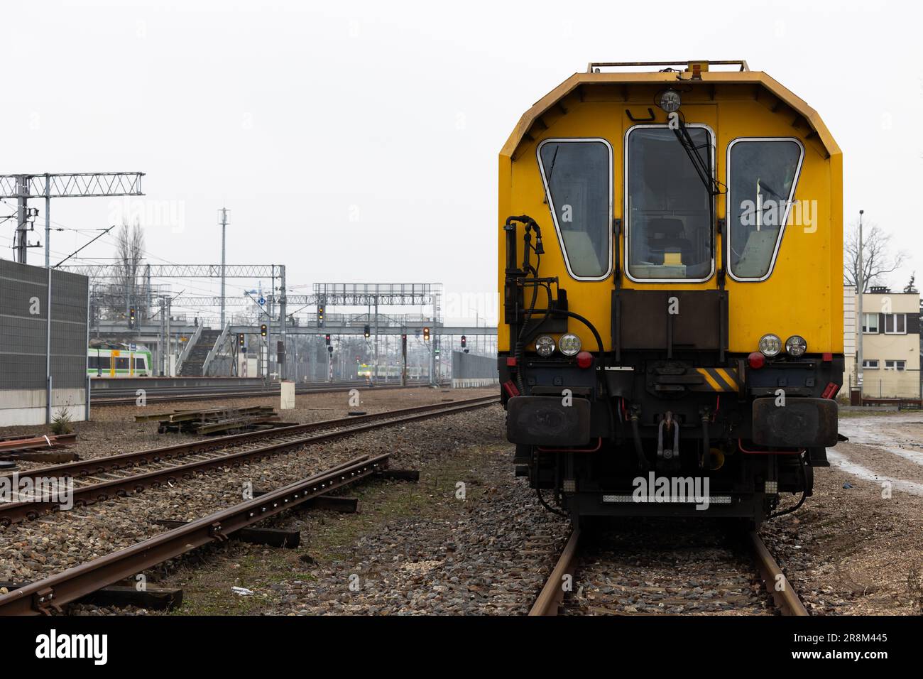 A yellow technical train for grinding rails standing on a railway ...