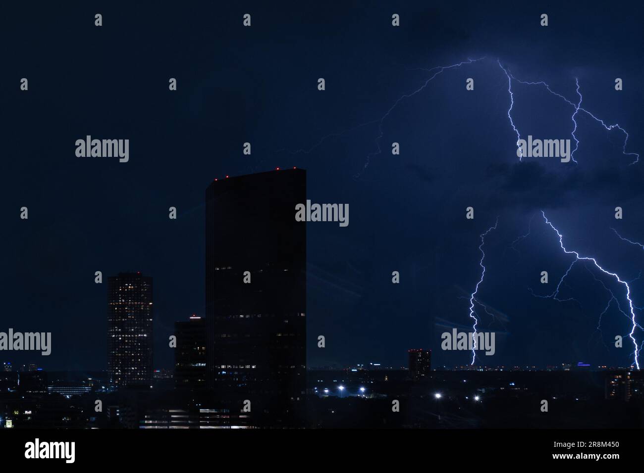 Texas, USA. 21st June, 2023. Lightning strikes the sky above the city ...