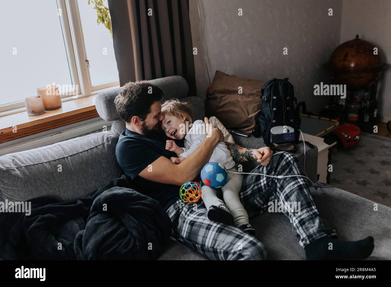 Father hugging disabled child on sofa Stock Photo - Alamy