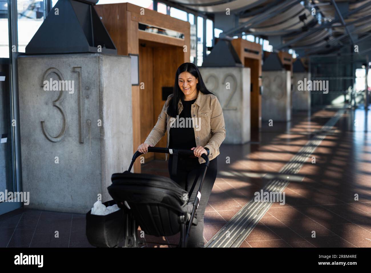 View of woman pushing pram at train station Stock Photo - Alamy