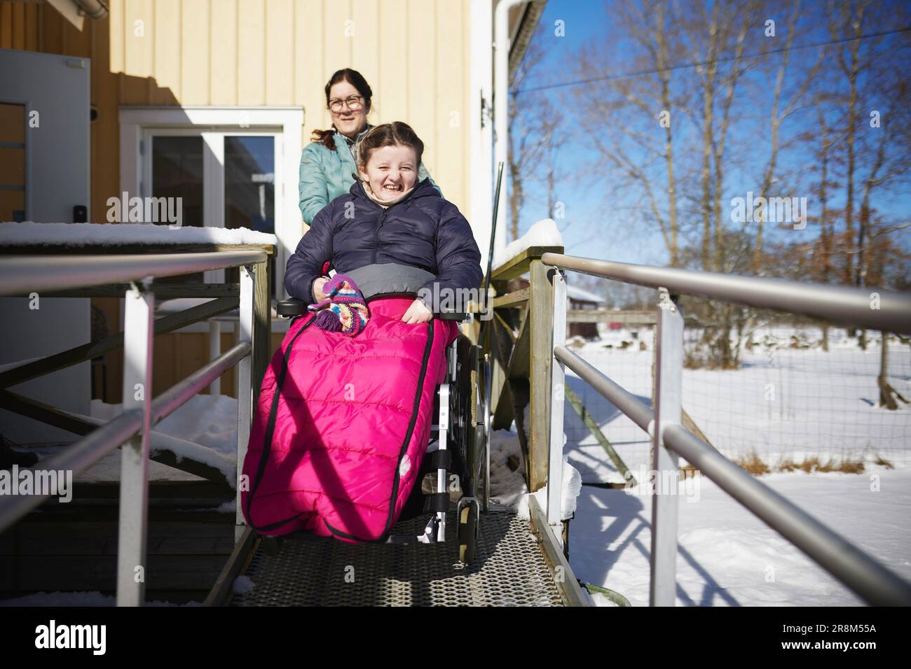 Girl pushing wheelchair hi-res stock photography and images - Alamy