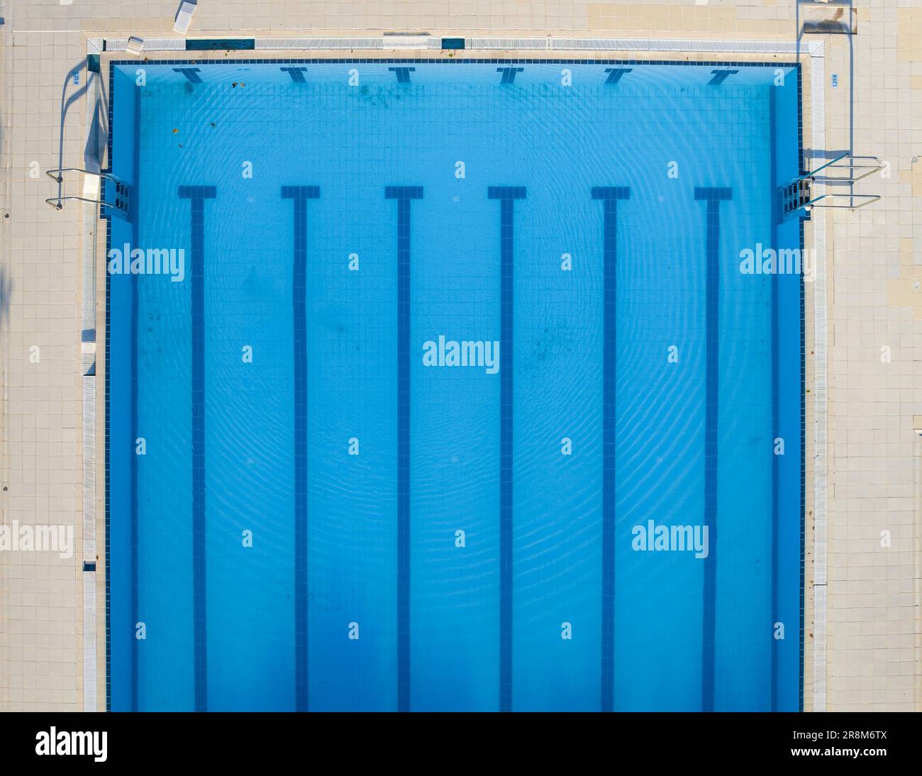Aerial zenithal view of the swimming pool of the village of Miralcamp ...