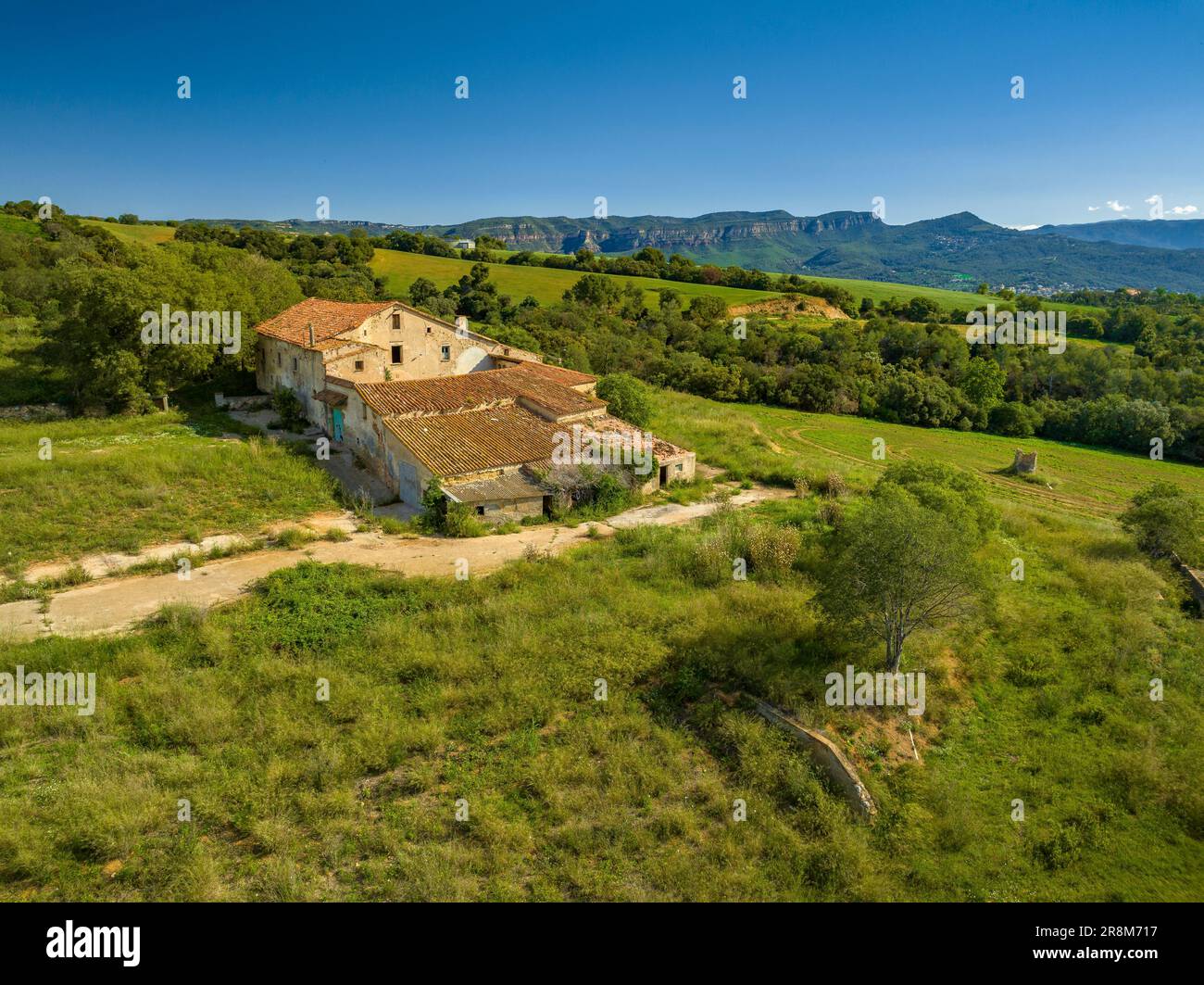 Can Rosàs farmhouse and its green rural surroundings in spring, in ...