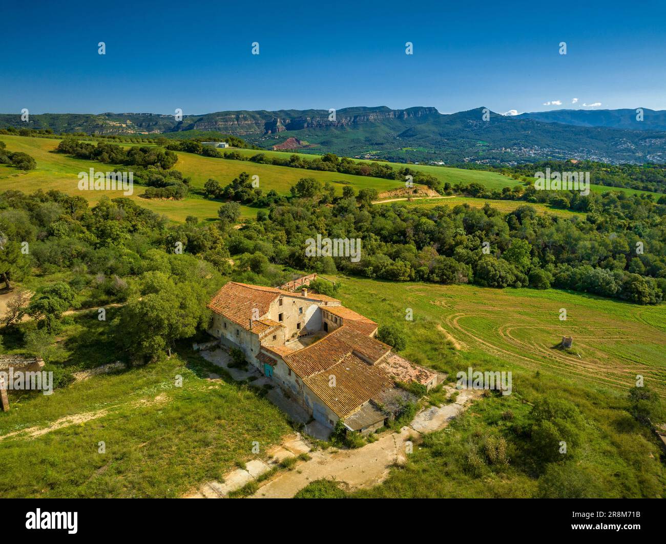 Can Rosàs farmhouse and its green rural surroundings in spring, in ...