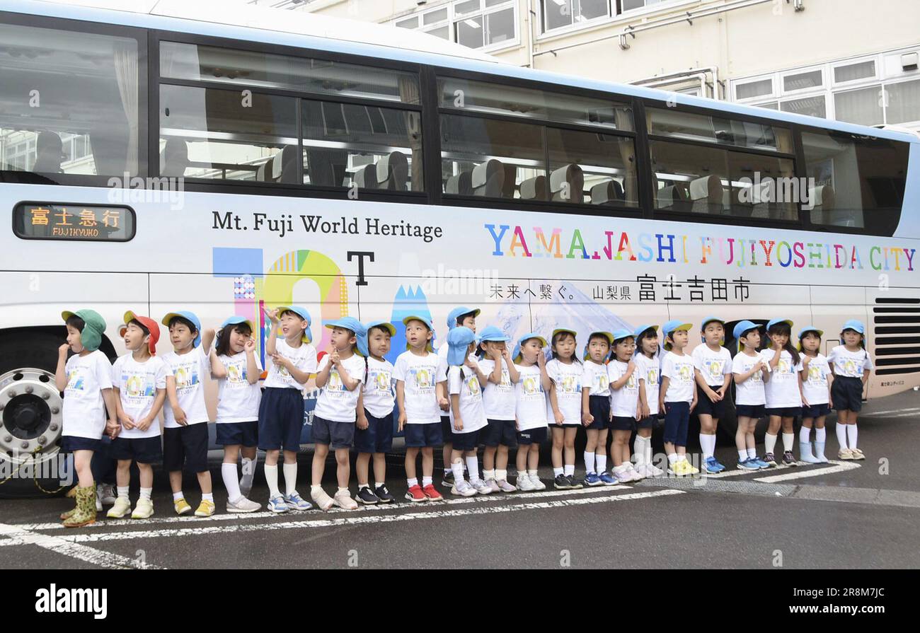 Nursery school children stand in front of a Mt. Fuji-themed bus during ...