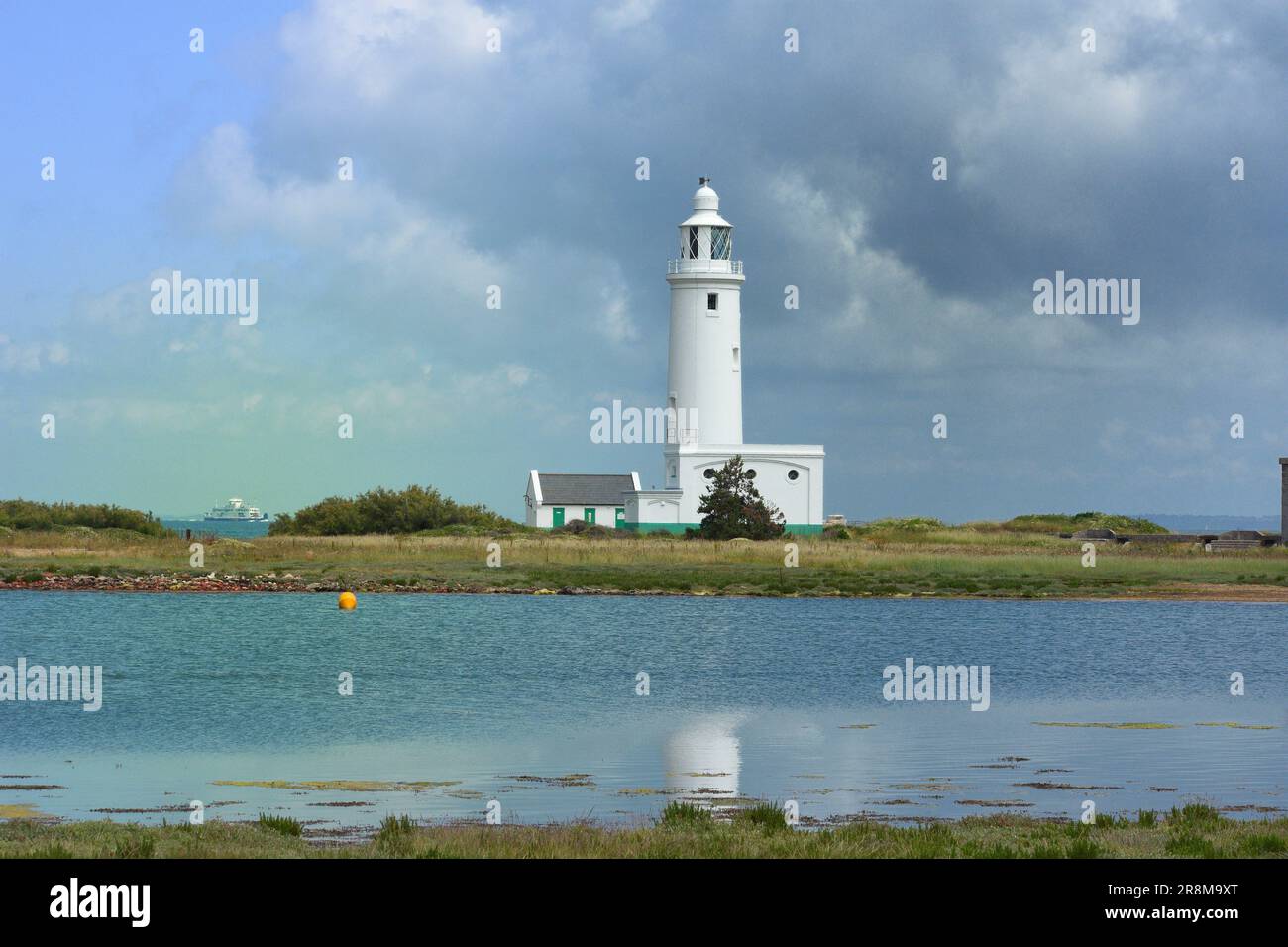 Hurst Point Lighthouse with reflection in the water Stock Photo - Alamy