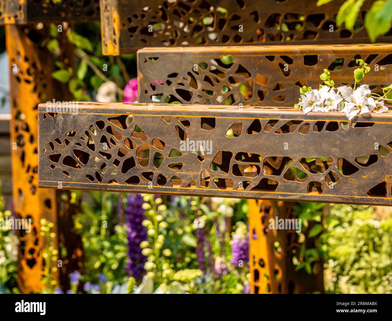 Close-up of decorative laser-cut Corten steel posts seen against ...