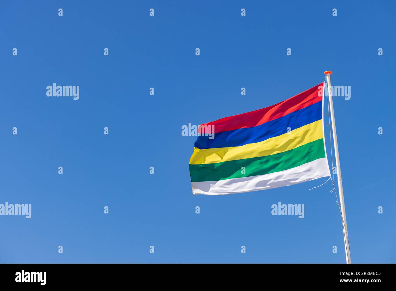 Waving flag of Terschelling in front of a blue sky at Wadden island ...