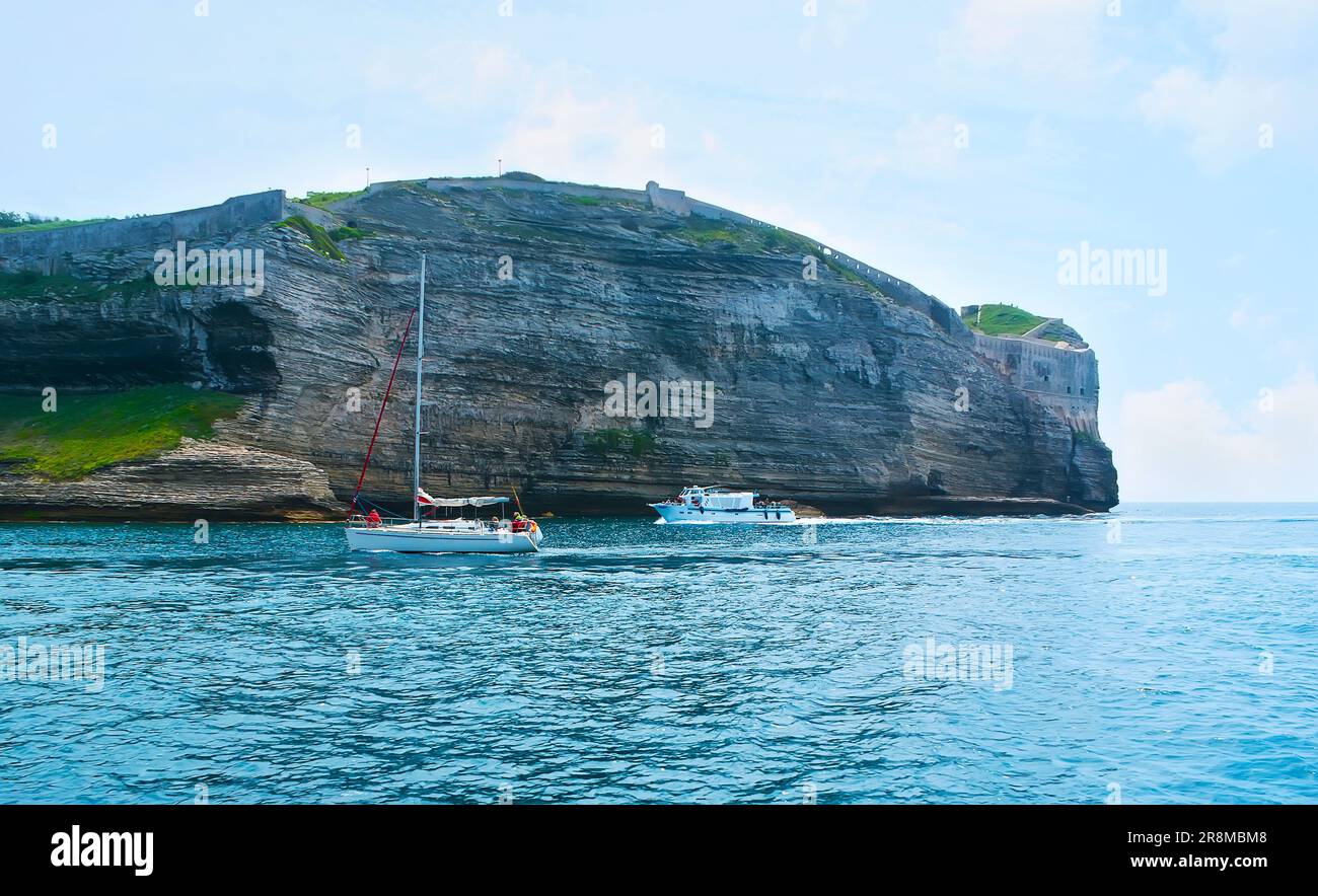 The tourist boats and yachts sail along the scenic rocky limestone ...