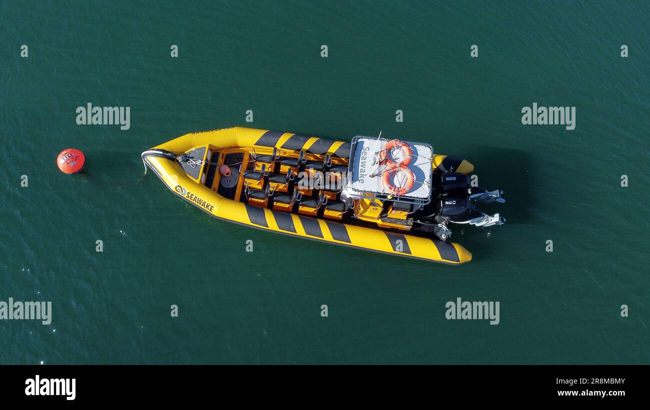 Aerial view of a yellow Seawake tourist boat cruising on the body of ...