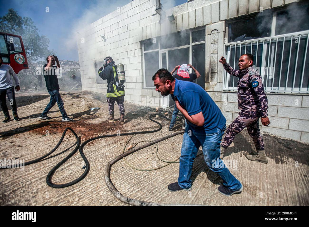Ramallah, Palestine. 21st June, 2023. Palestinians try to extinguish a ...