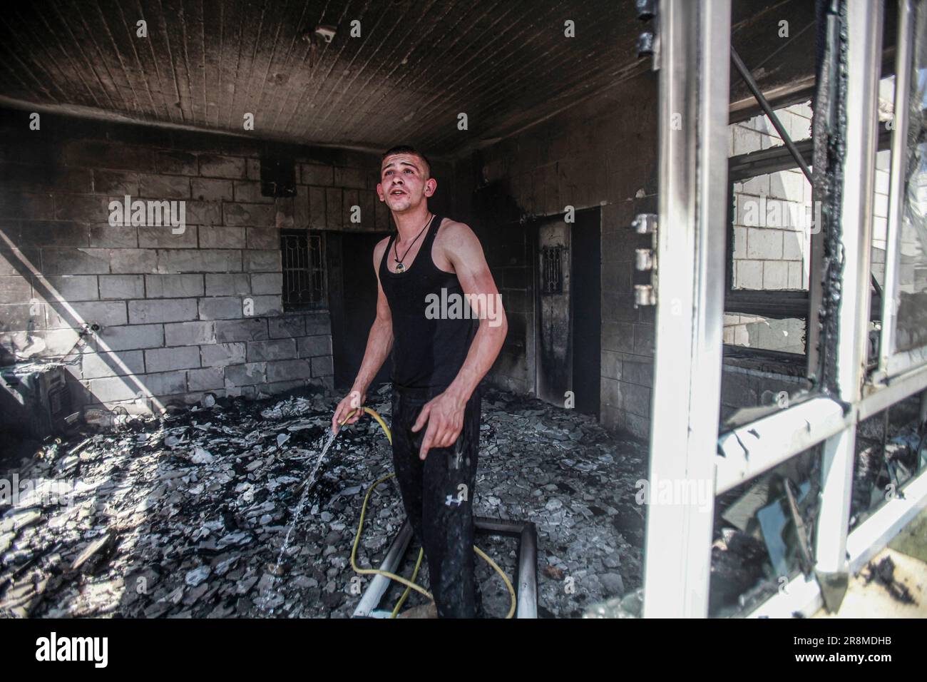 Ramallah, Palestine. 21st June, 2023. Palestinians try to extinguish a ...