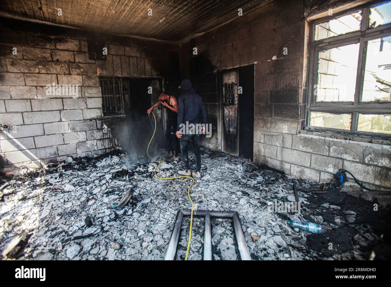 Ramallah, Palestine. 21st June, 2023. Palestinians try to extinguish a ...